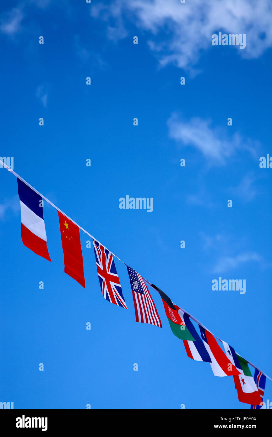 Flags of the world blowing in the breeze on a warm sunny spring day ...