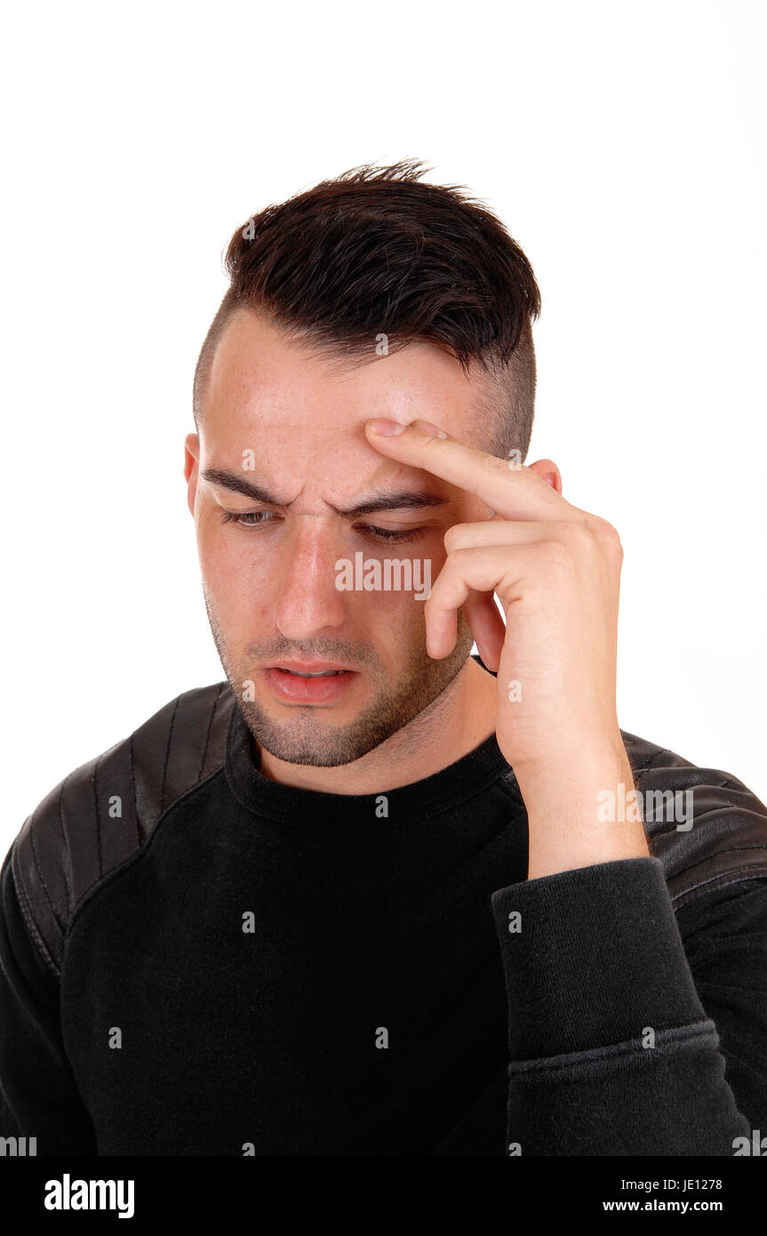 A young handsome man in a portrait with his finger on his forehead ...