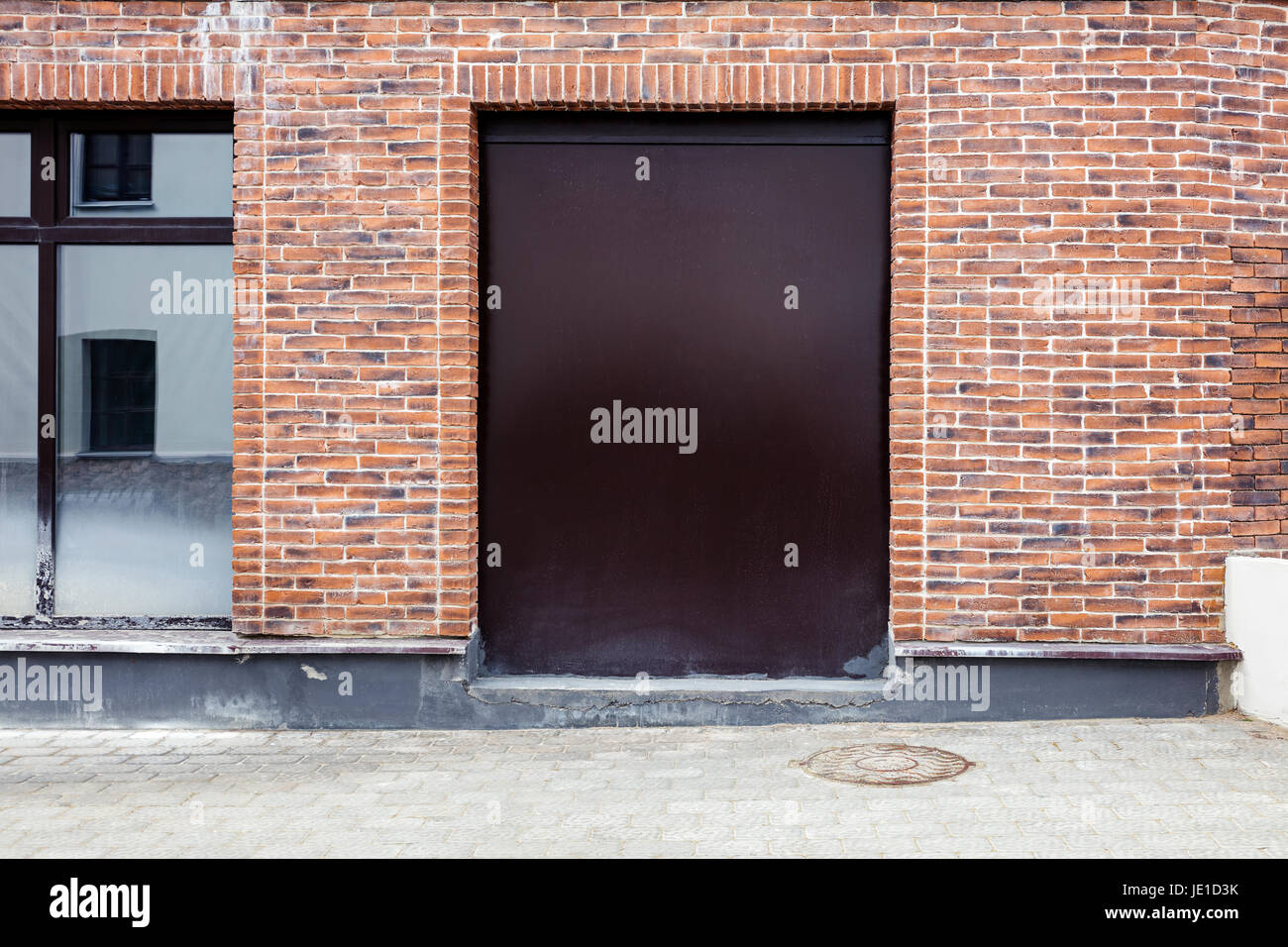 closed metal doorway painted brown on red brick wall background Stock ...