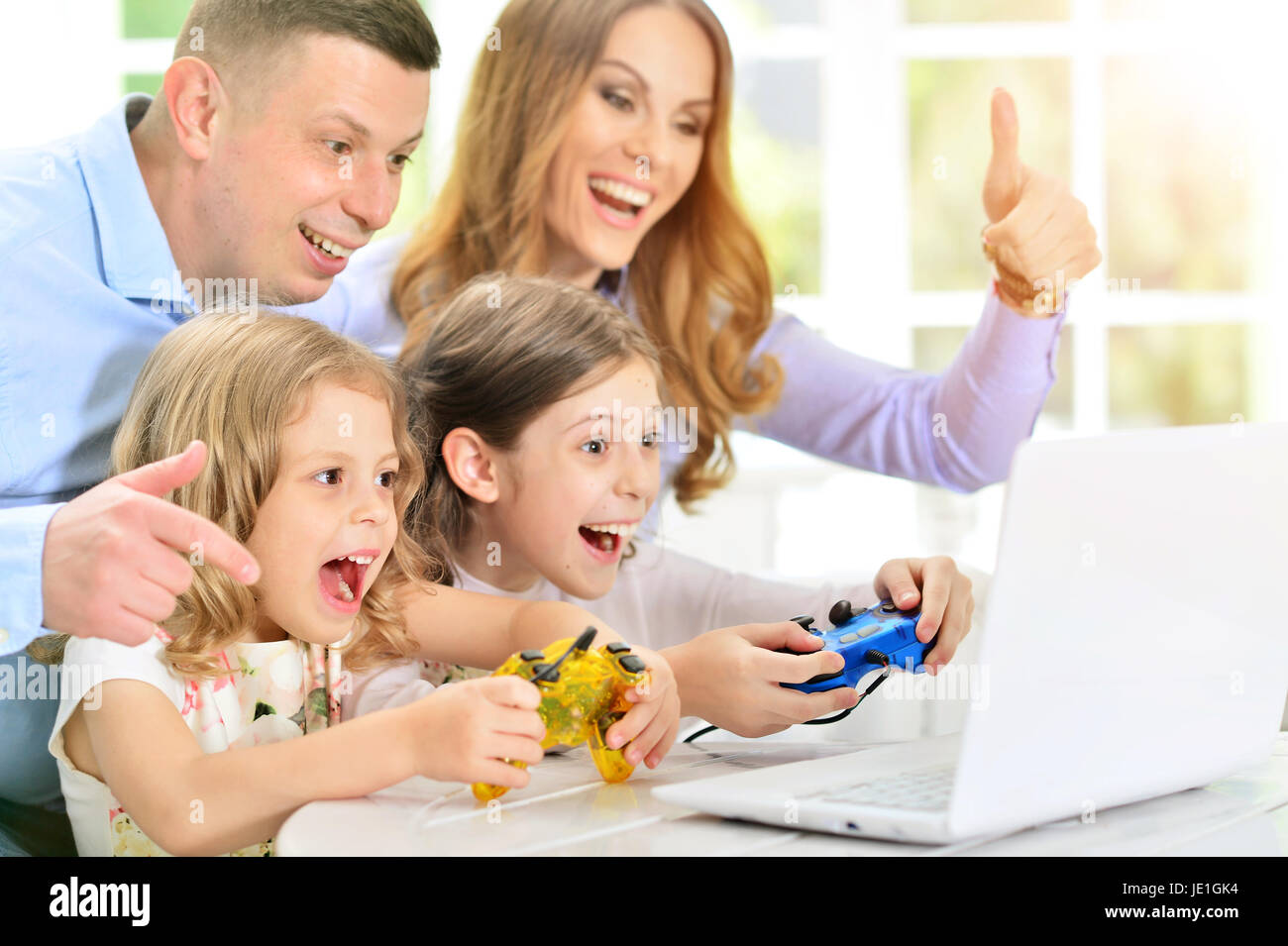 Children table sit laptop smile hi-res stock photography and images - Alamy