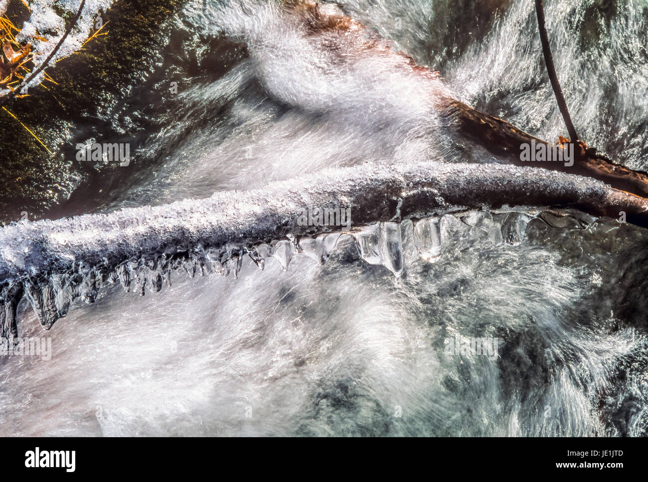 Frozen log accross stream in winter Stock Photo - Alamy
