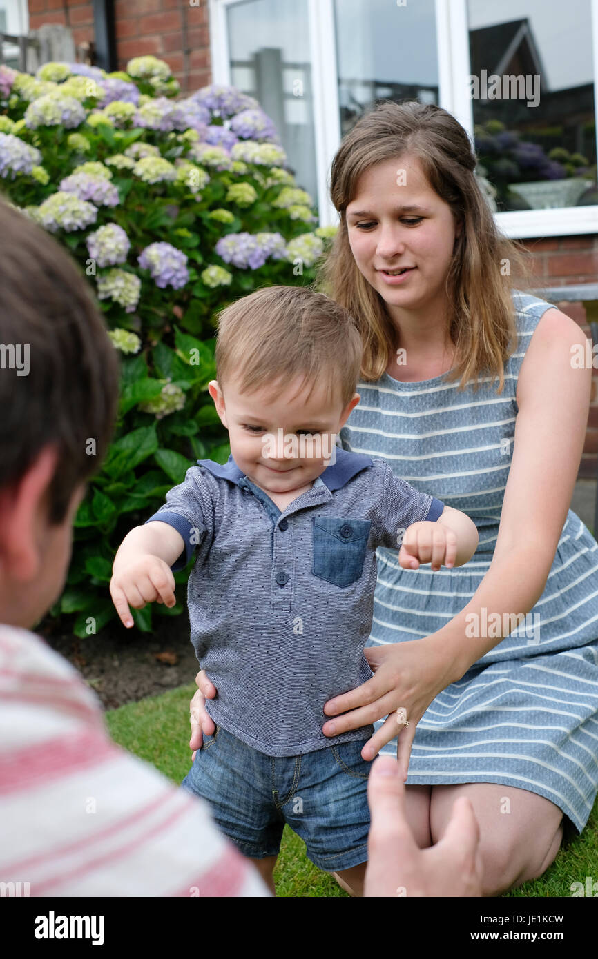 One year old baby boy taking first steps Stock Photo - Alamy