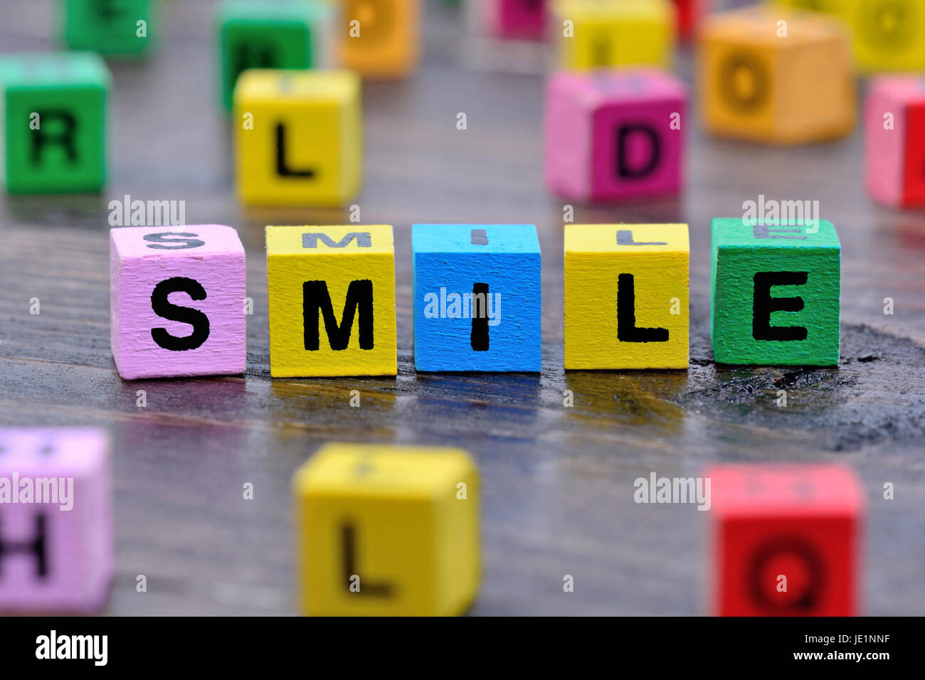 Smile word on wooden table Stock Photo - Alamy