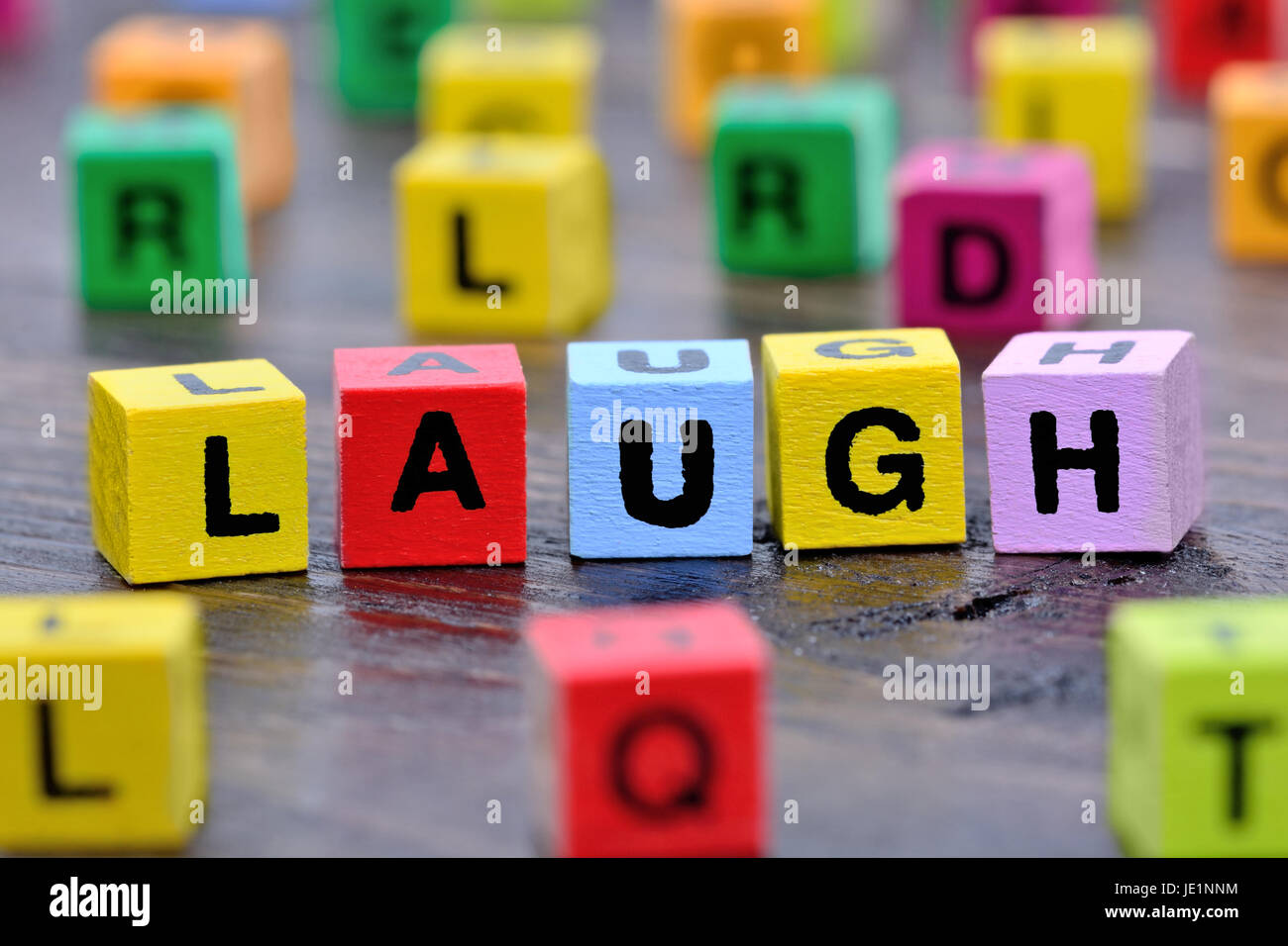 The word Laugh on wooden table Stock Photo - Alamy