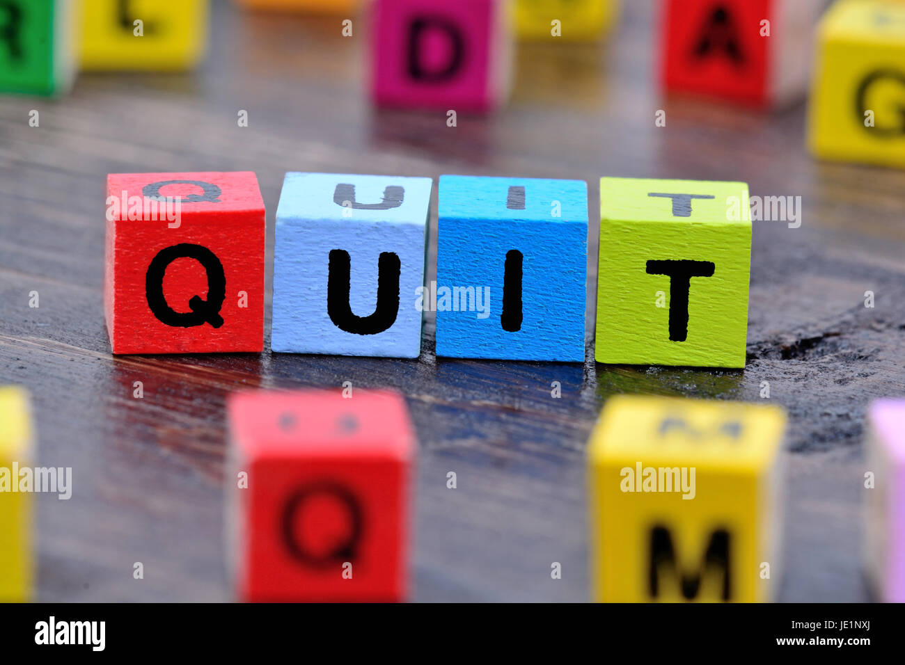 Quit word on wooden table Stock Photo - Alamy