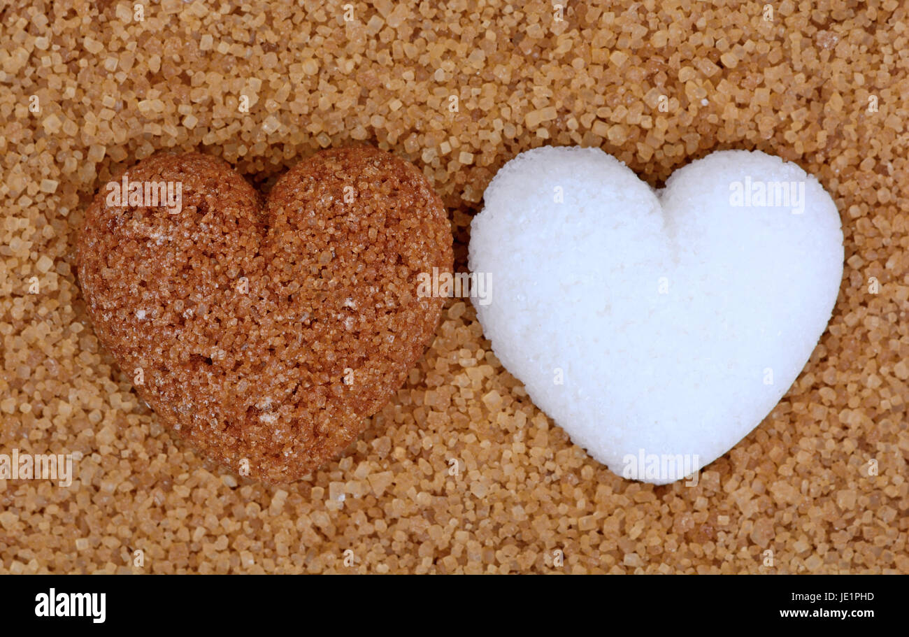 Beige sugar heart with white sugar heart on sugar background closeup ...