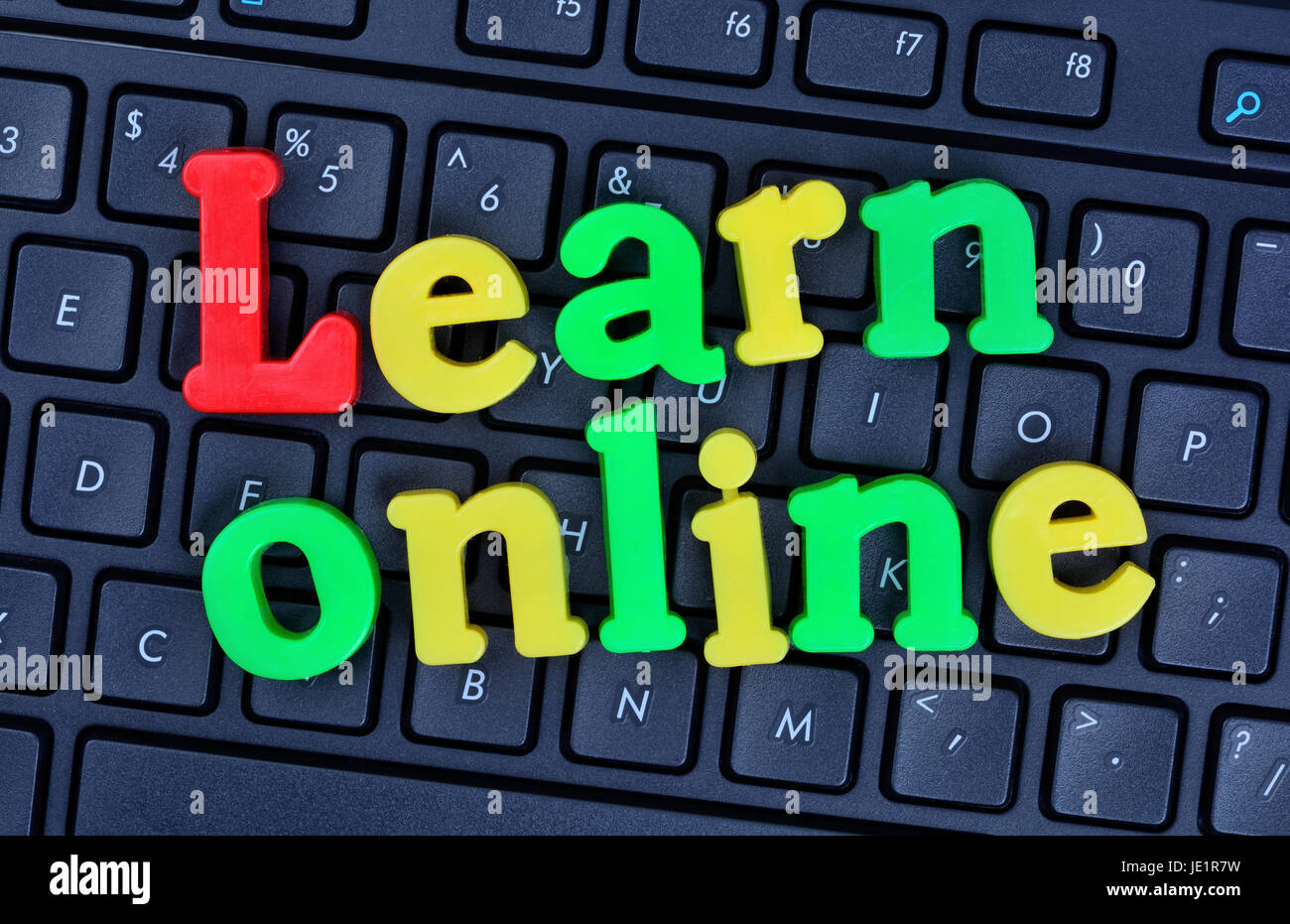 Learn online words on computer keyboard closeup Stock Photo - Alamy