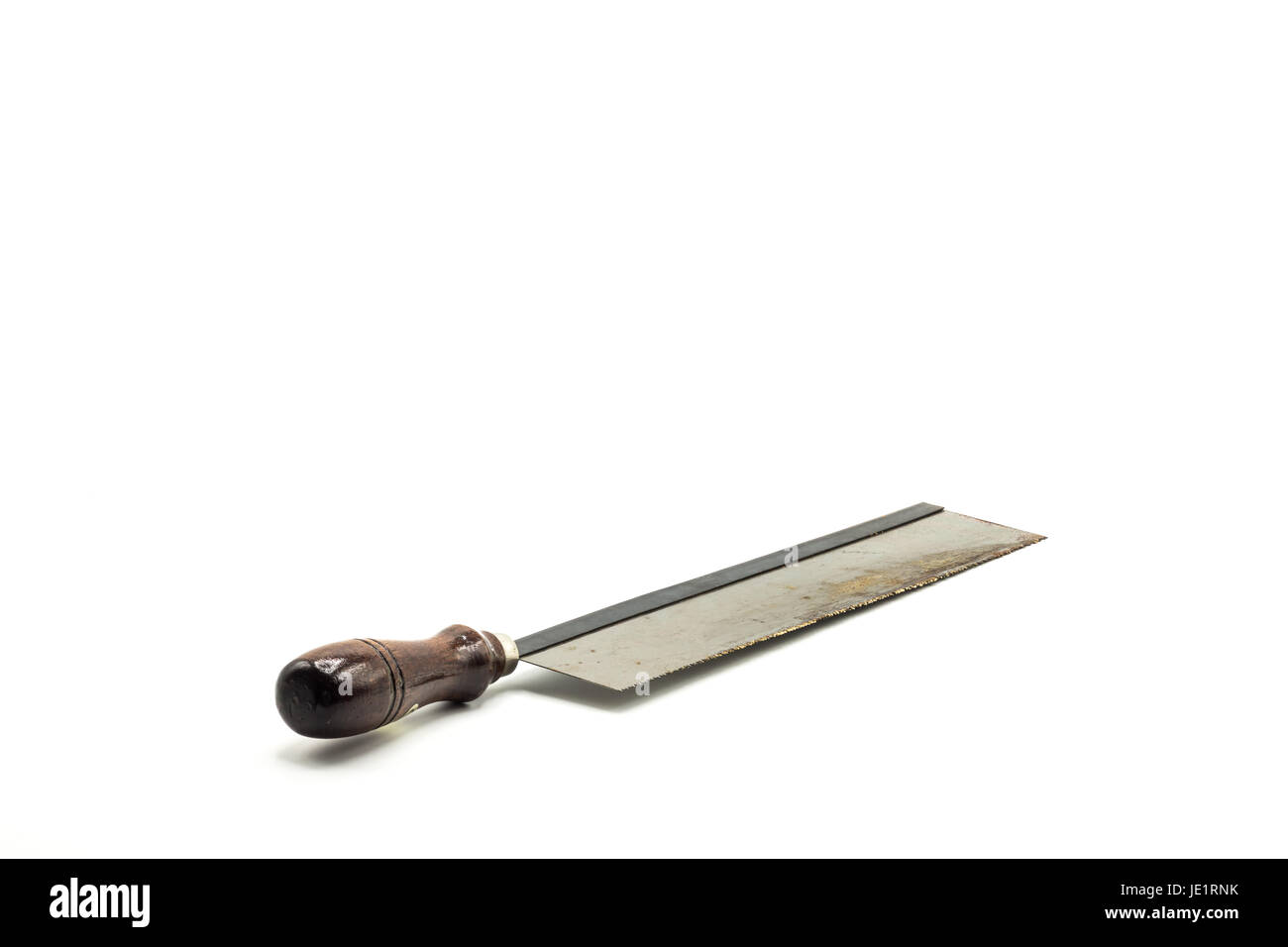 Used and old hand saw for cutting slim wood in construction industry ...