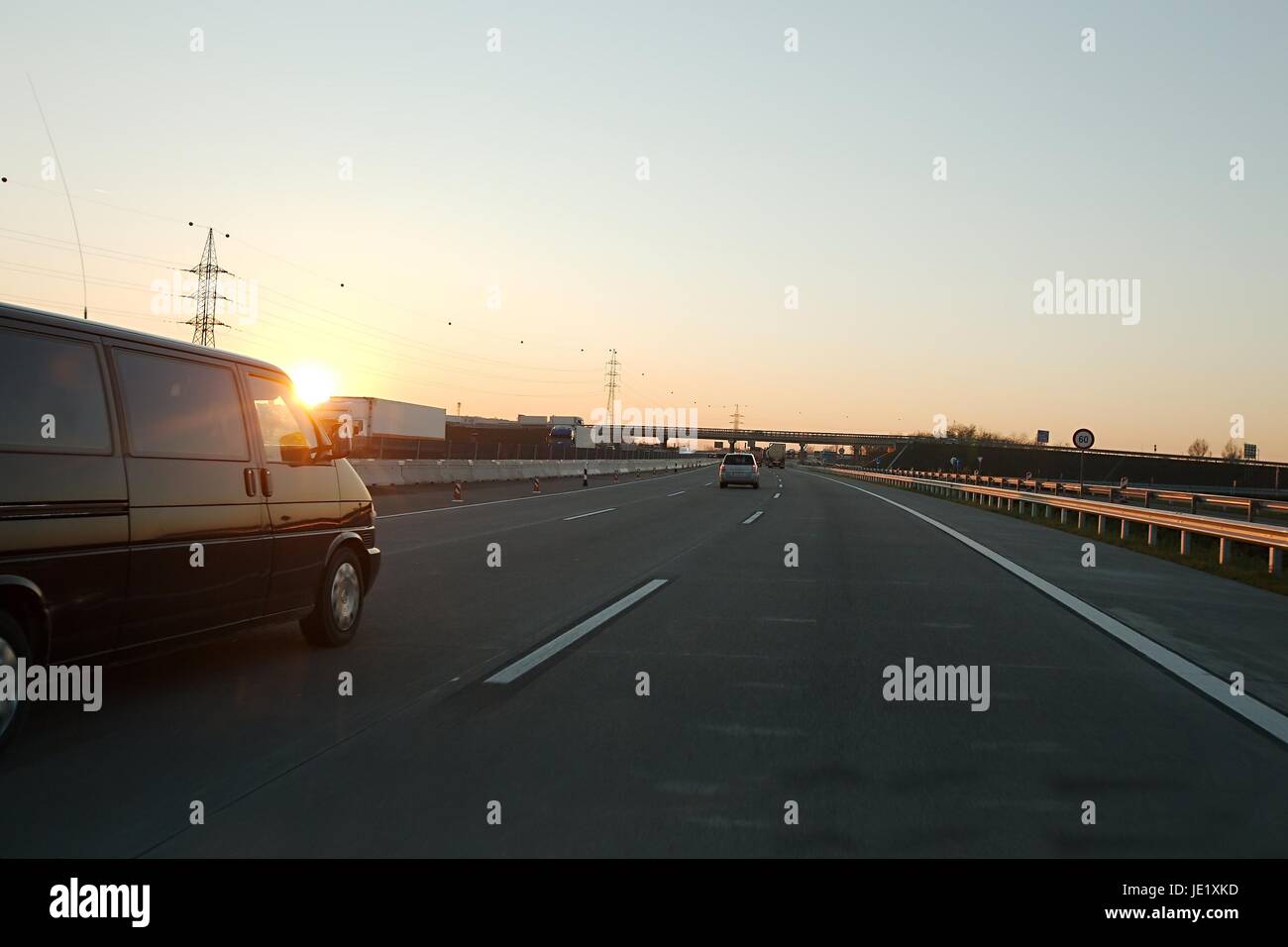 Driving on the highway in the flare of the setting sun Stock Photo - Alamy