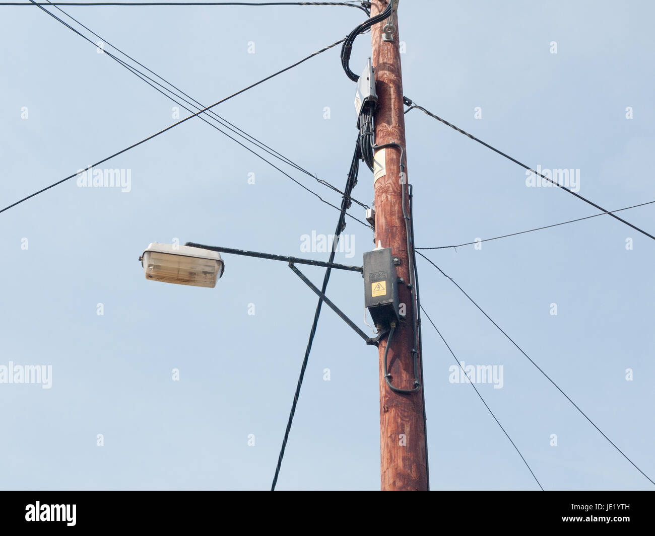a lamp post with various wires and boxes Stock Photo - Alamy