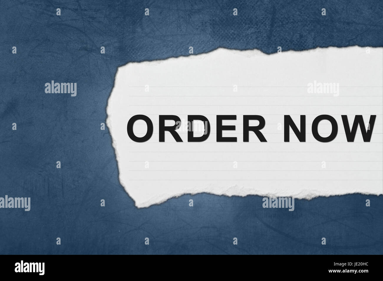 order now with white paper tears on blue texture Stock Photo - Alamy