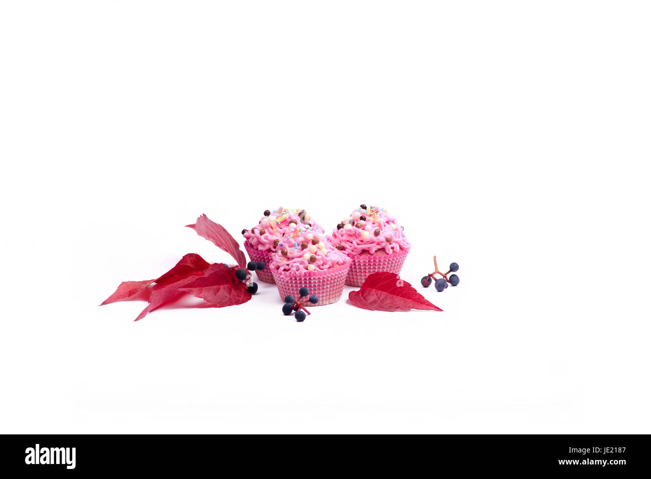 pink colored fresh muffins with different candies Stock Photo - Alamy