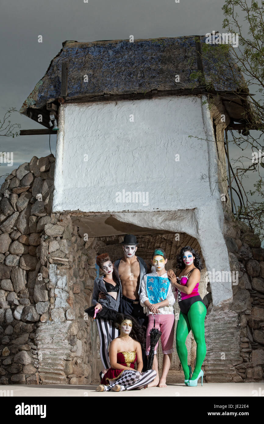 Circus ensemble posing at outdoor stone stage Stock Photo - Alamy