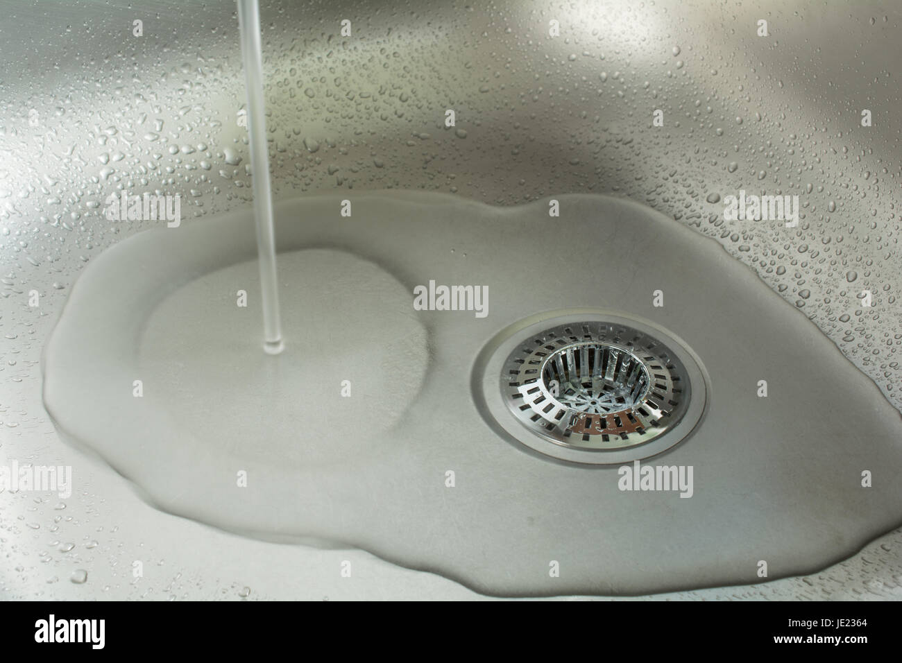 Sink With Waterdrops, Water Jet And Chrome Drain Strainer Stock Photo ...