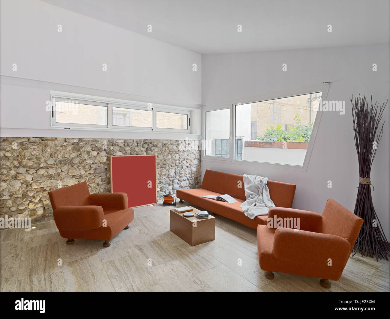 interior view of a modern living room with orange sofa ans marble floor ...