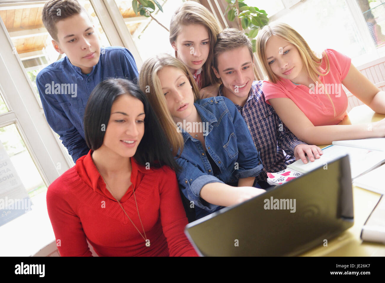 happy young teens group in school have fun an learning lessons Stock ...