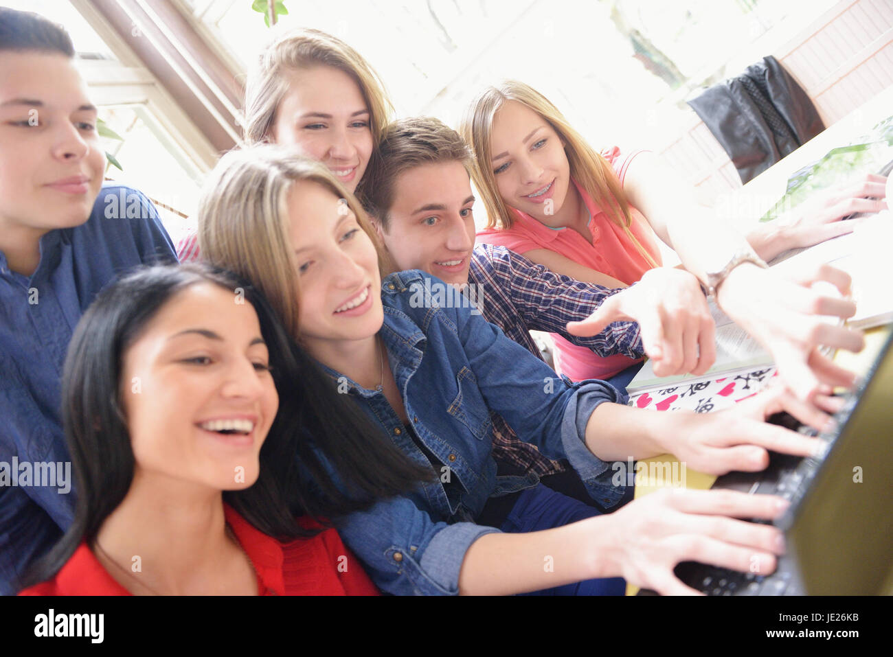 happy young teens group in school have fun an learning lessons Stock ...