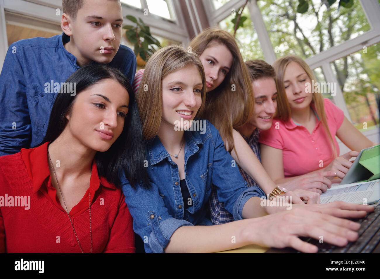 happy young teens group in school have fun an learning lessons Stock ...