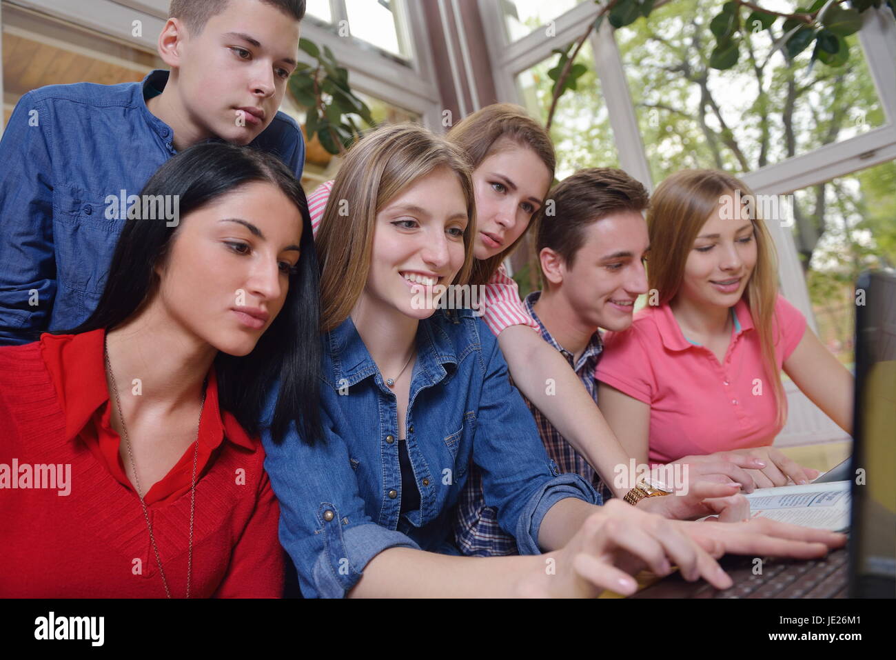 happy young teens group in school have fun an learning lessons Stock ...