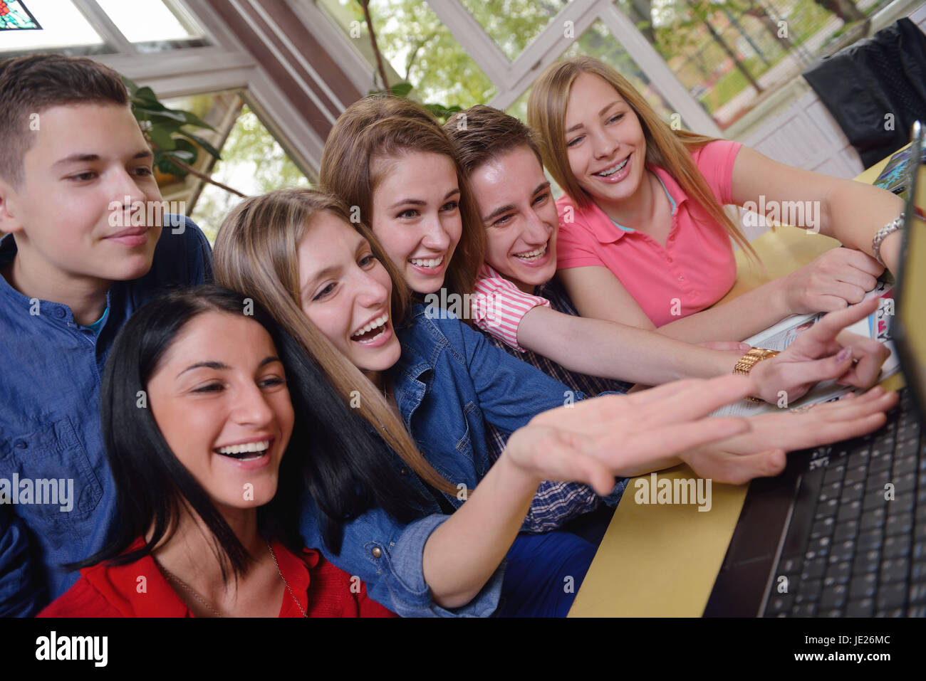 happy young teens group in school have fun an learning lessons Stock ...