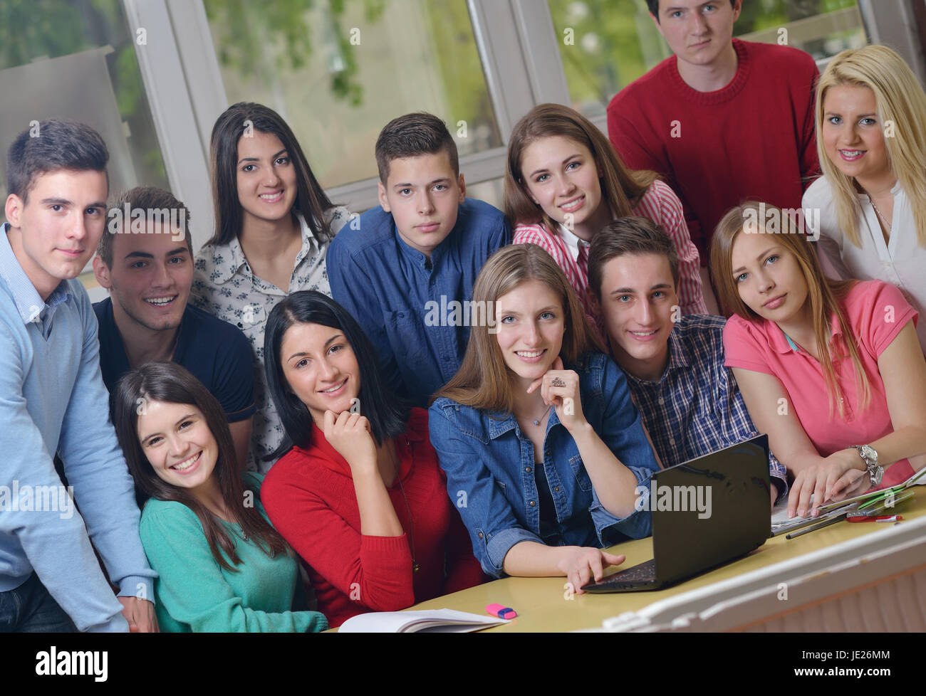 happy young teens group in school have fun an learning lessons Stock ...