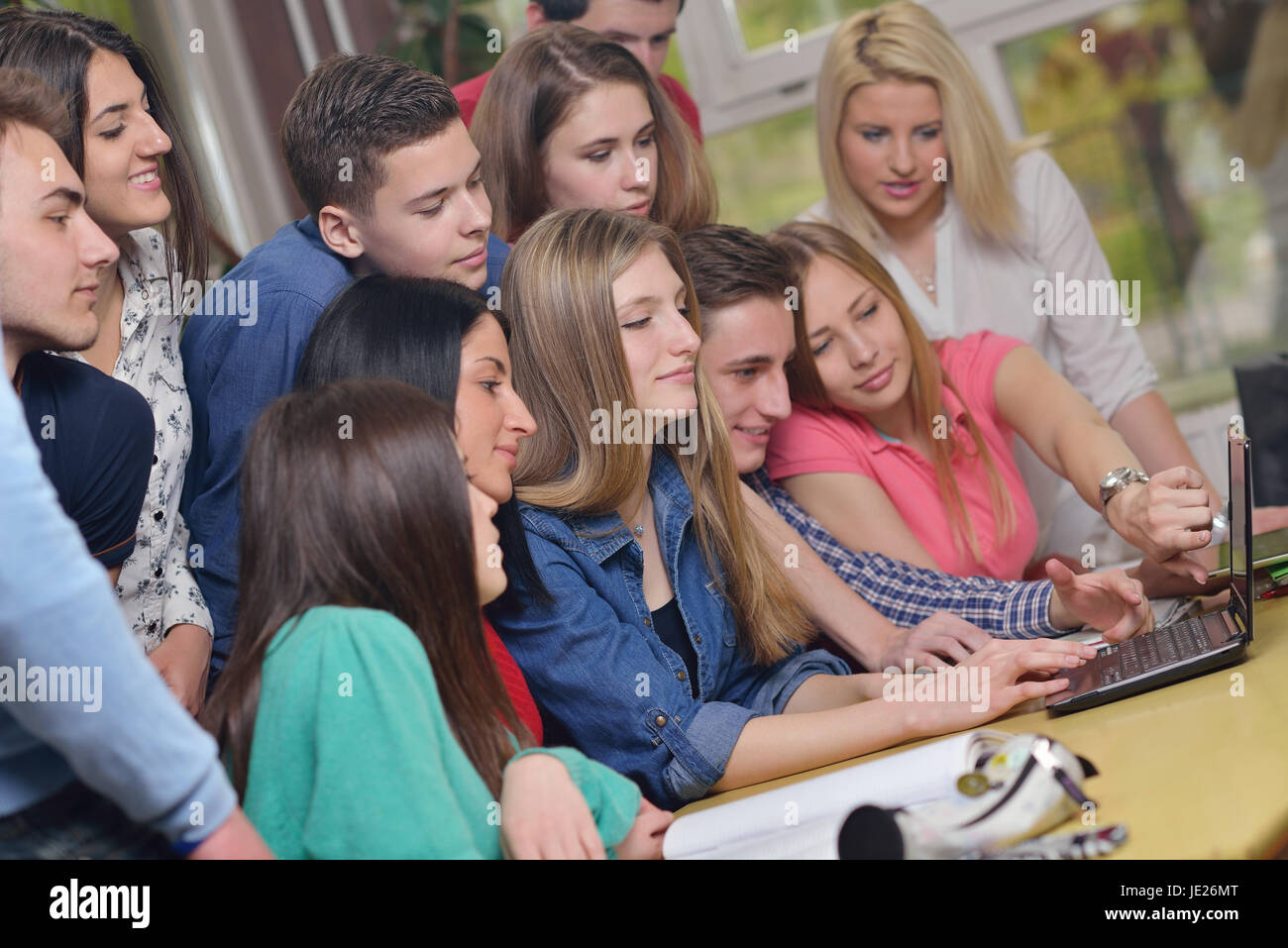 happy young teens group in school have fun an learning lessons Stock ...