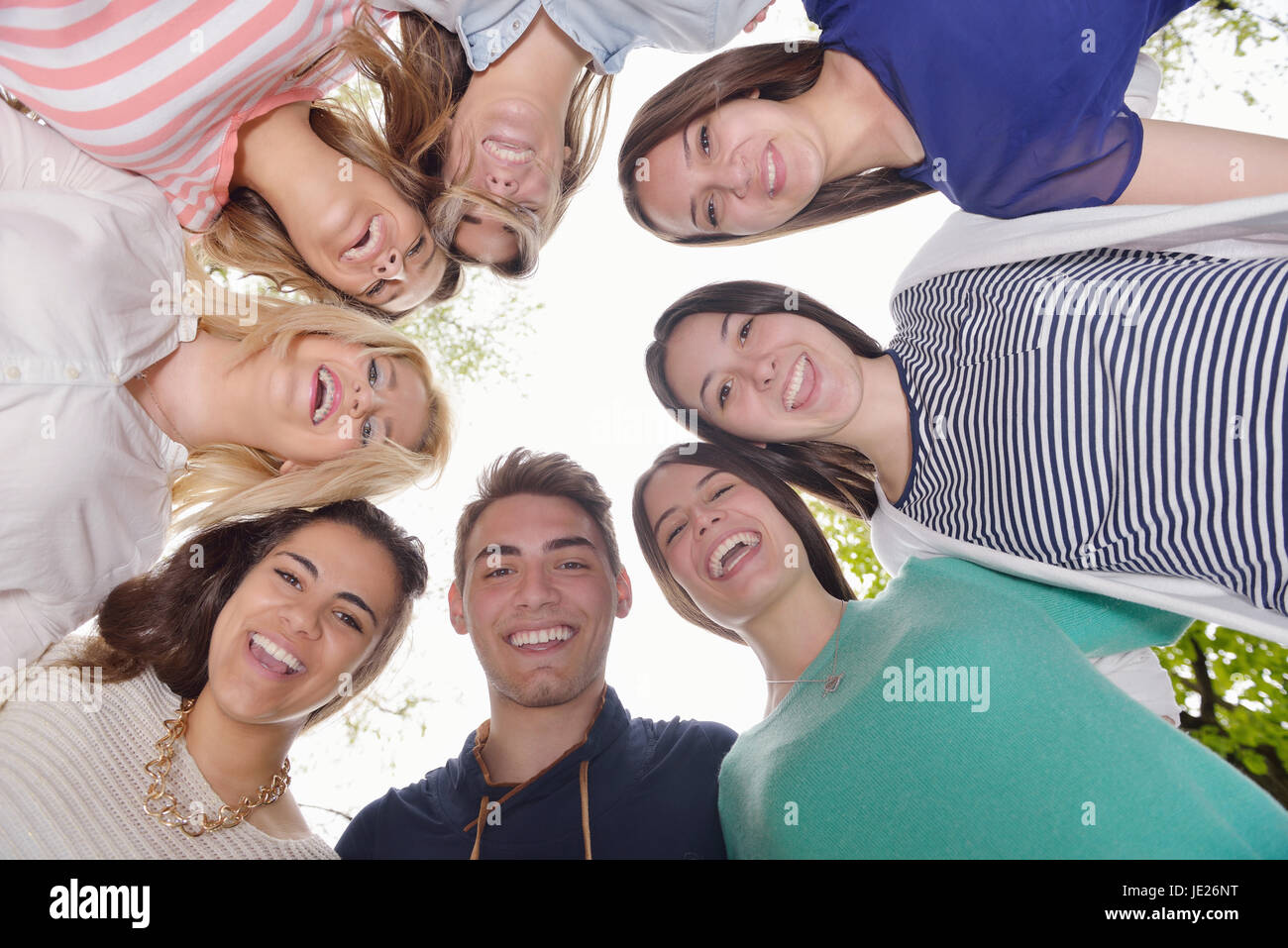 Happy smiling group of young friends staying together outdoor in the ...