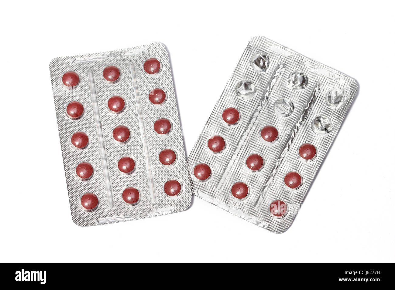Red tablets in blisters on white background Stock Photo - Alamy