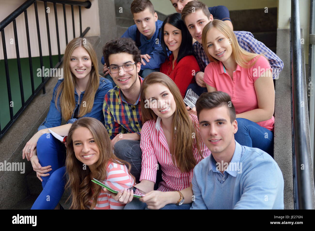 happy young teens group in school have fun an learning lessons Stock ...