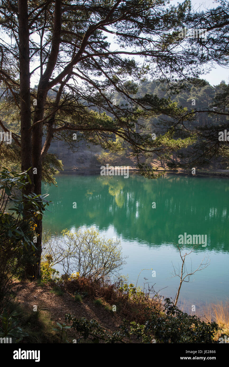 Beautiful landscape image of old clay pit quarry lake with unusual ...