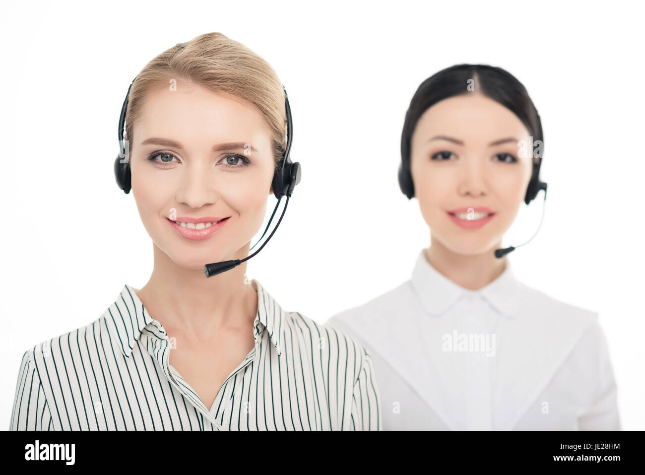 portrait of smiling call center operators in headsets isolated on white Stock Photo - Alamy