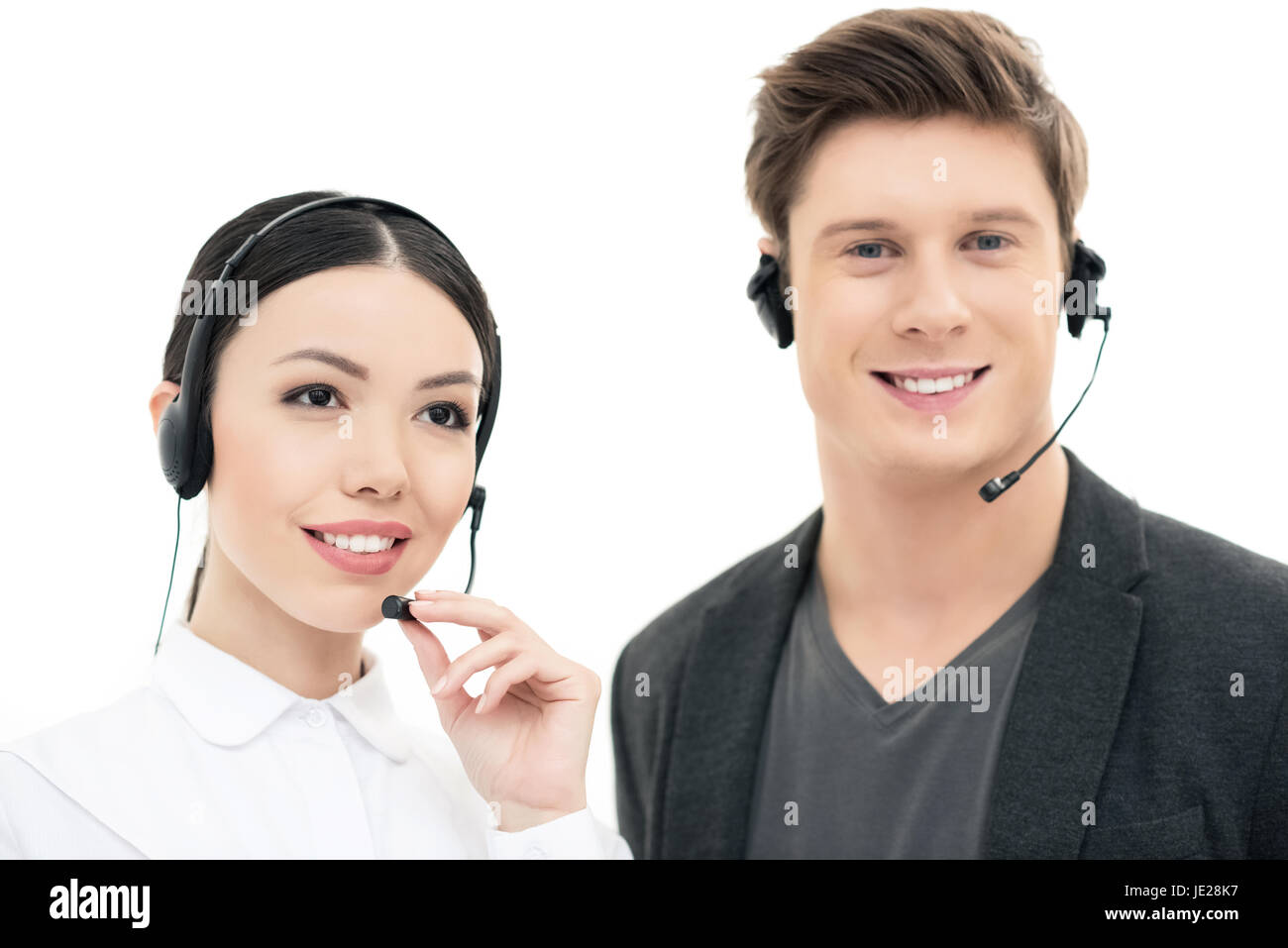 portrait of smiling call center operators in headsets isolated on white ...
