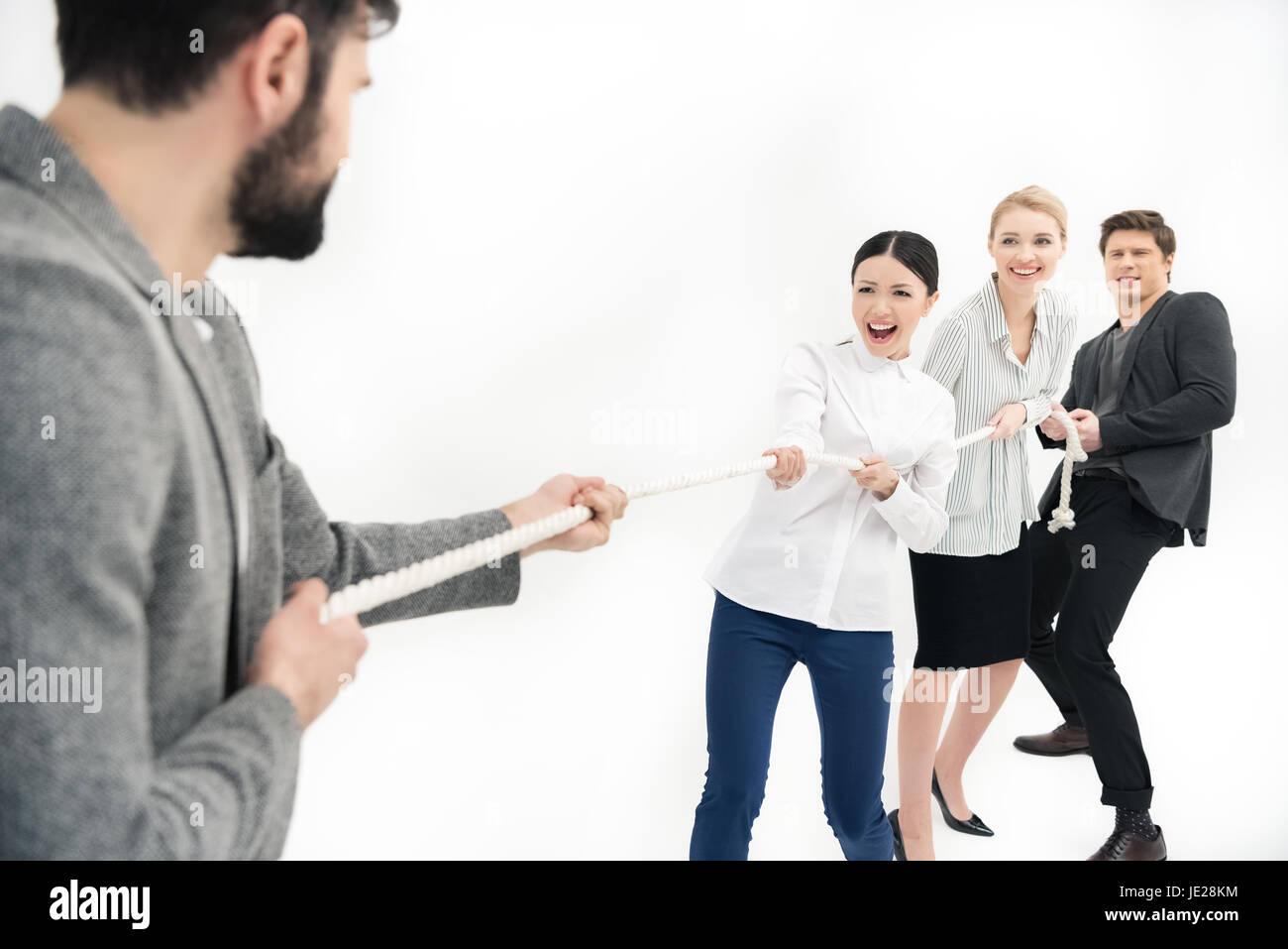 group of business people pulling over rope isolated on white Stock ...