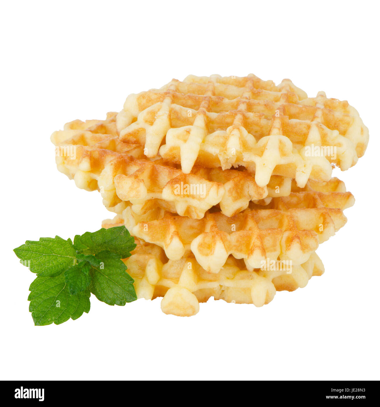 Pile of sweet waffles with green mint leaves isolated on white ...