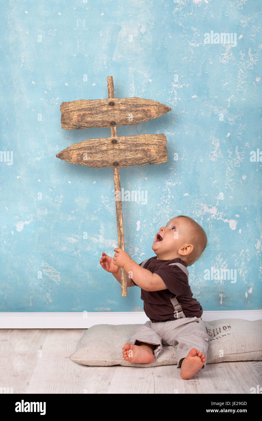 child holding wooden sign Stock Photo - Alamy