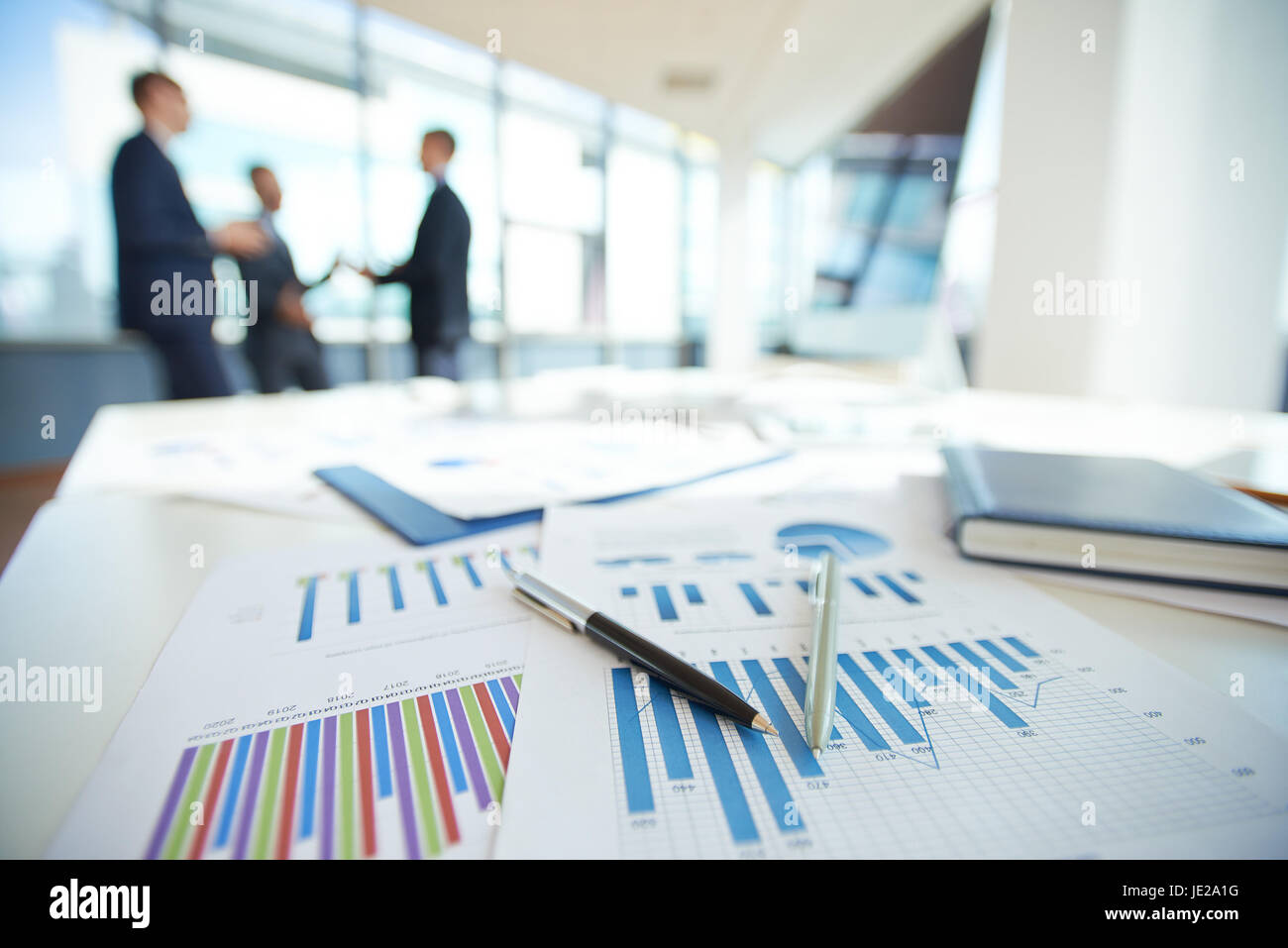 Spreadsheets with charts on office table Stock Photo - Alamy