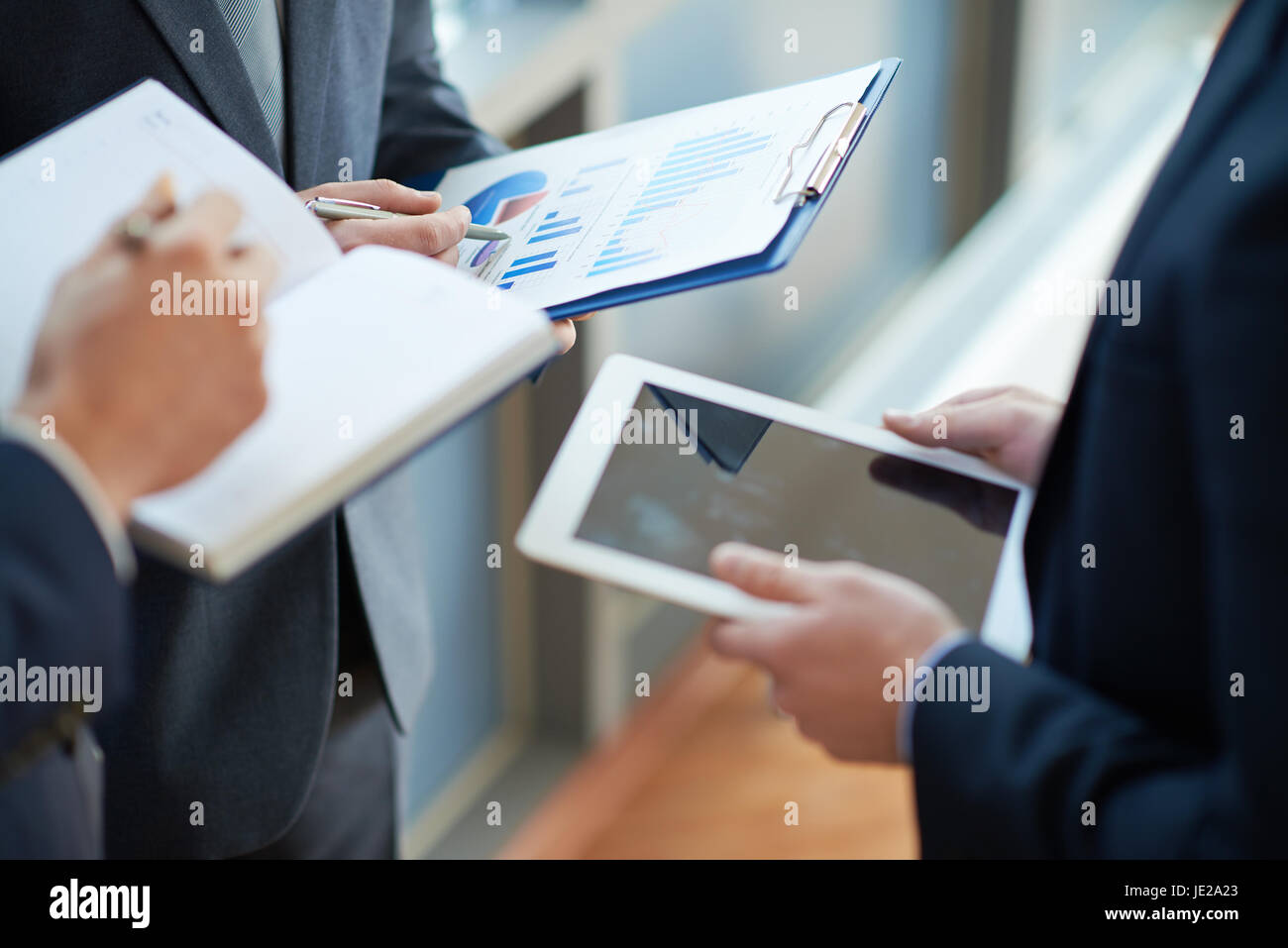 Colleagues discussing statistics Stock Photo - Alamy