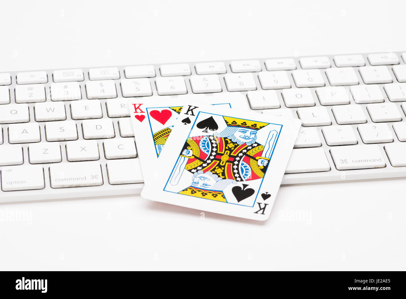 Poker cards on web keyboard on white background Stock Photo - Alamy