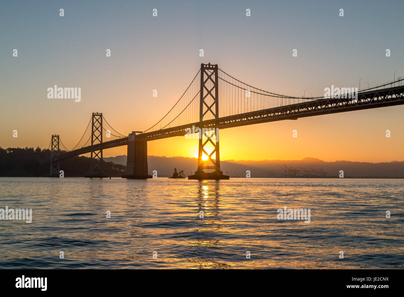 Sun rise in between the Pilar of the Bay Bridge Stock Photo - Alamy