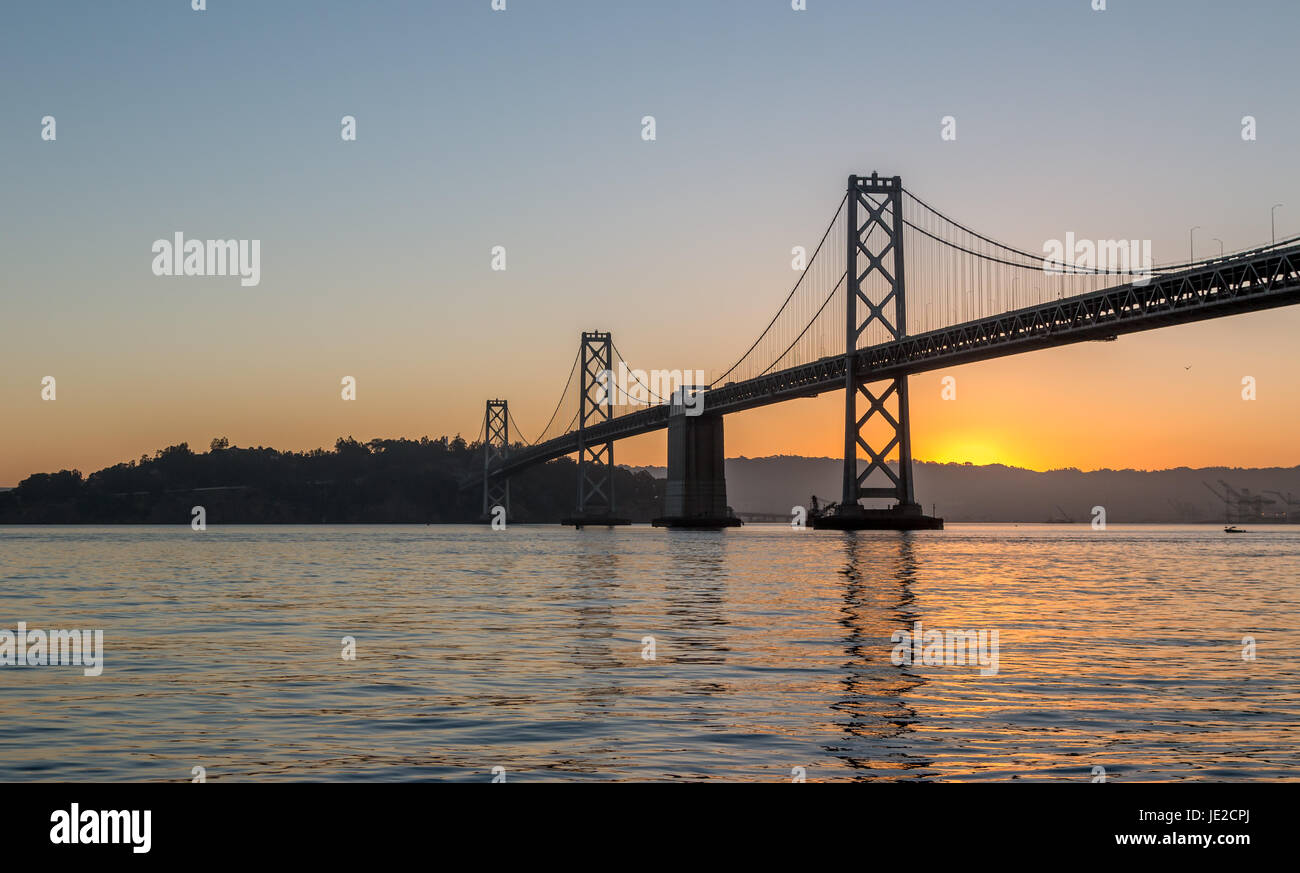 Sun Rising Behind the Bay Bridge Stock Photo - Alamy