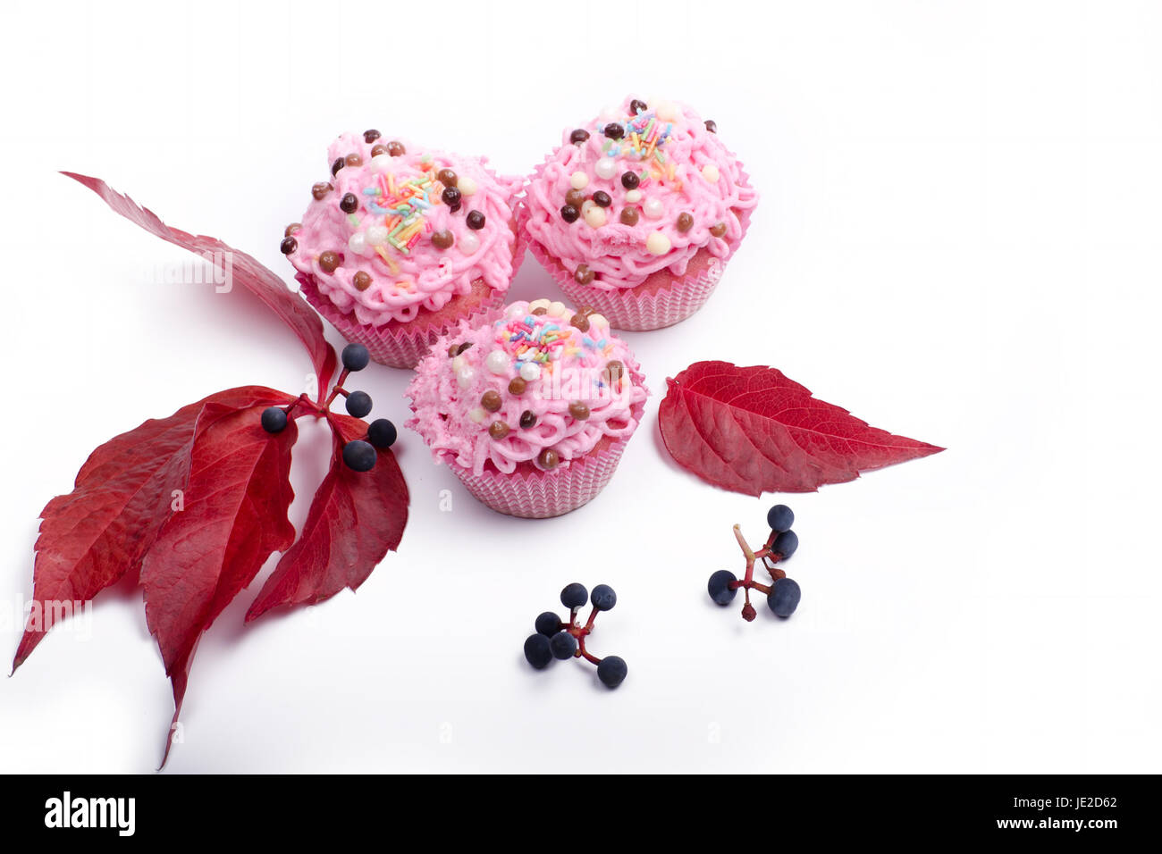 pink colored fresh muffins with different candies Stock Photo - Alamy