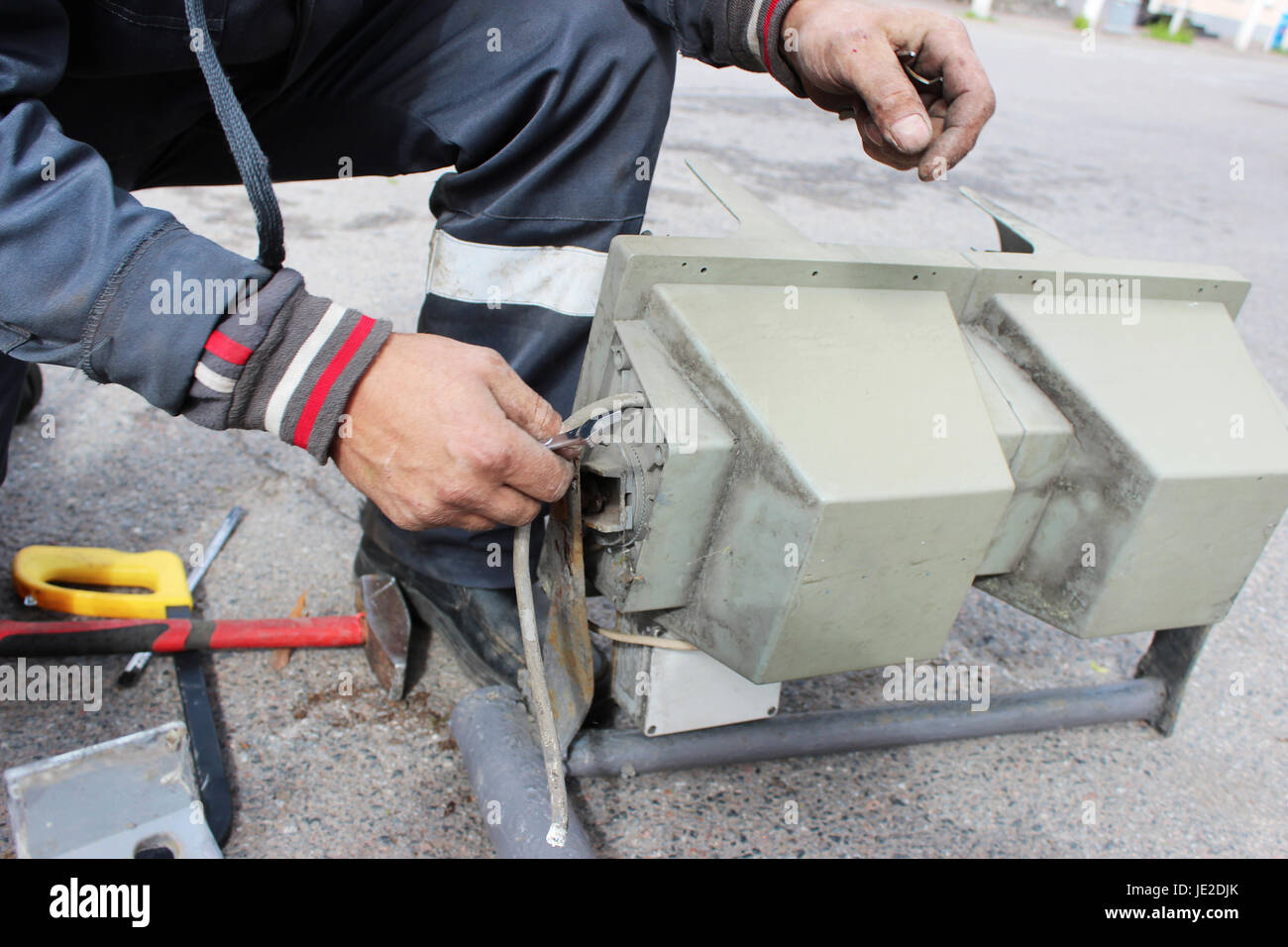 The worker replaces the broken traffic light with a working traffic ...