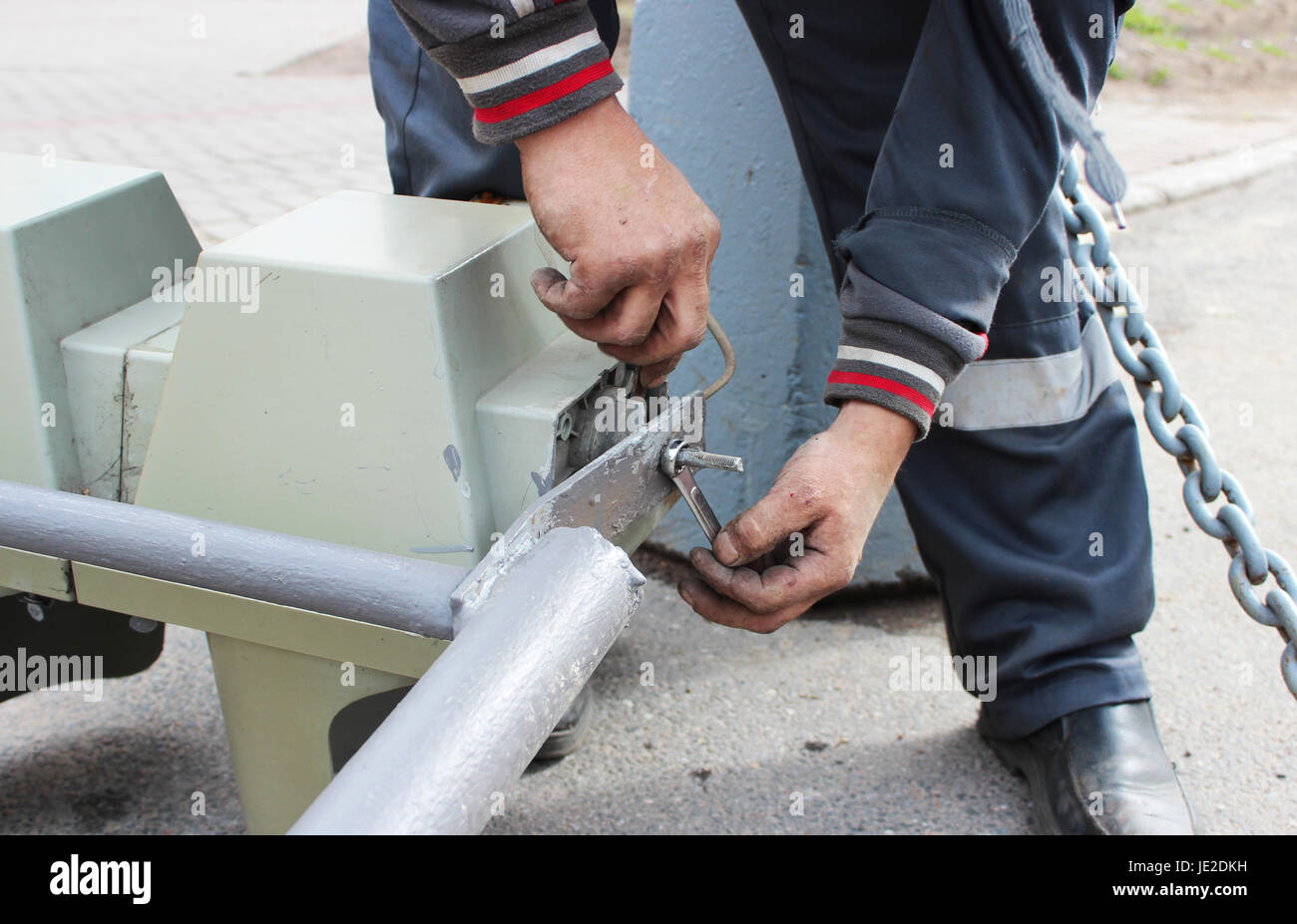 The worker replaces the broken traffic light with a working traffic ...