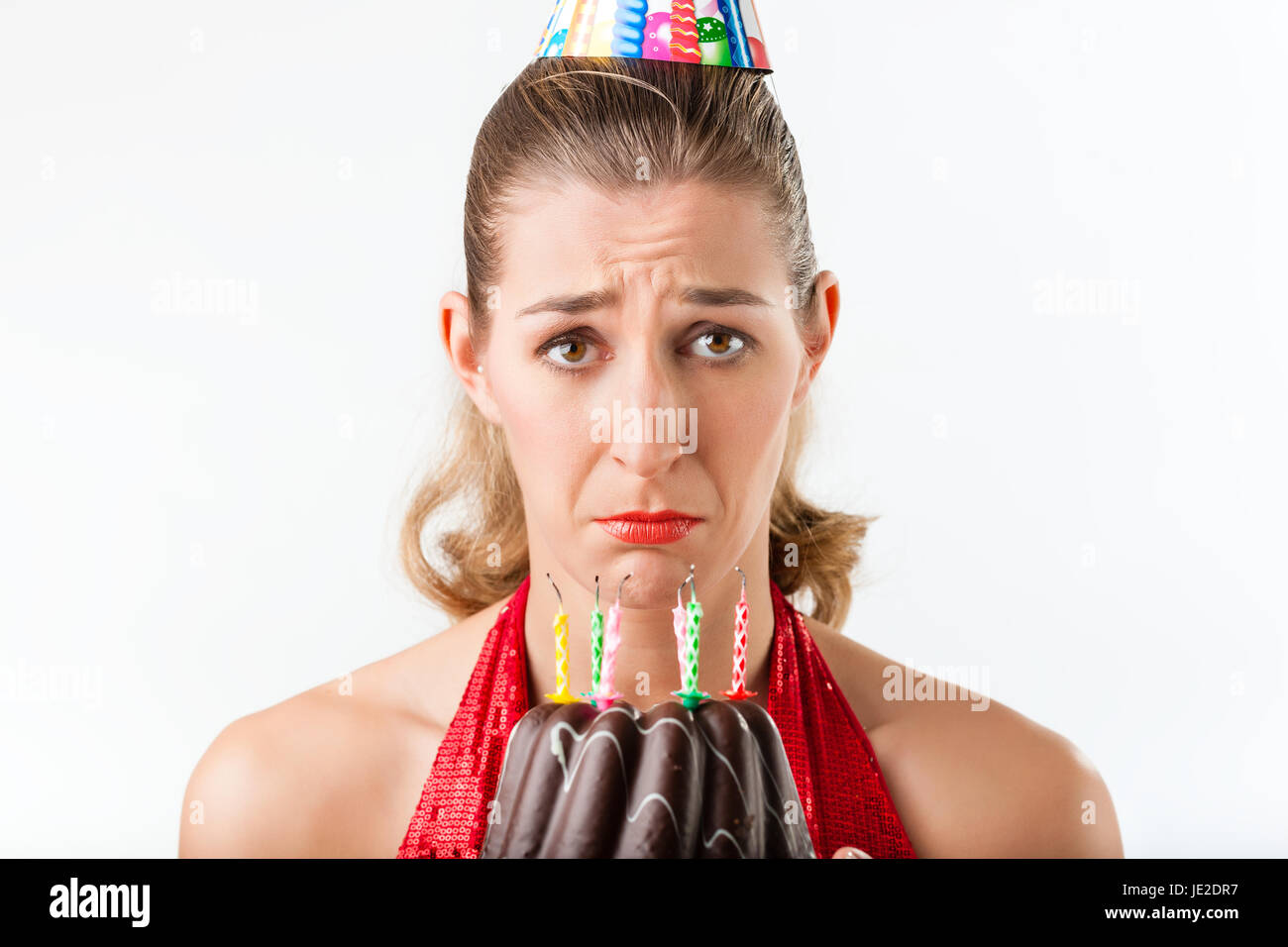 Woman celebrating birthday with cake candles are wiped out, she is ...