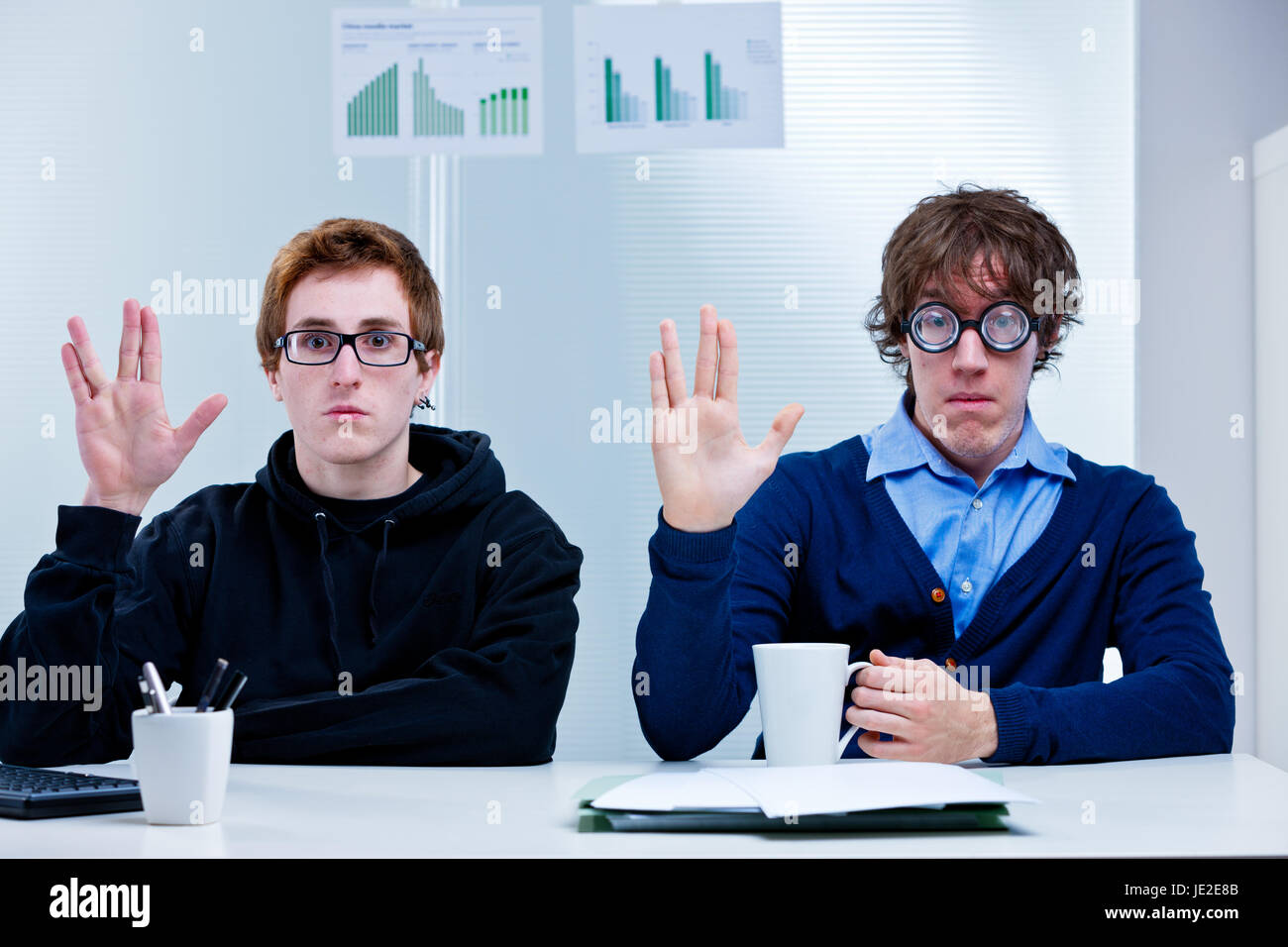 a couple of nerd office workers showing a very popular science fiction ...