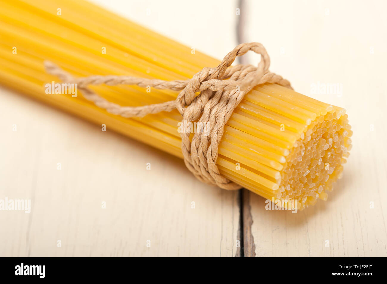 Italian pasta spaghetti tied with a rope on a rustic table Stock Photo ...