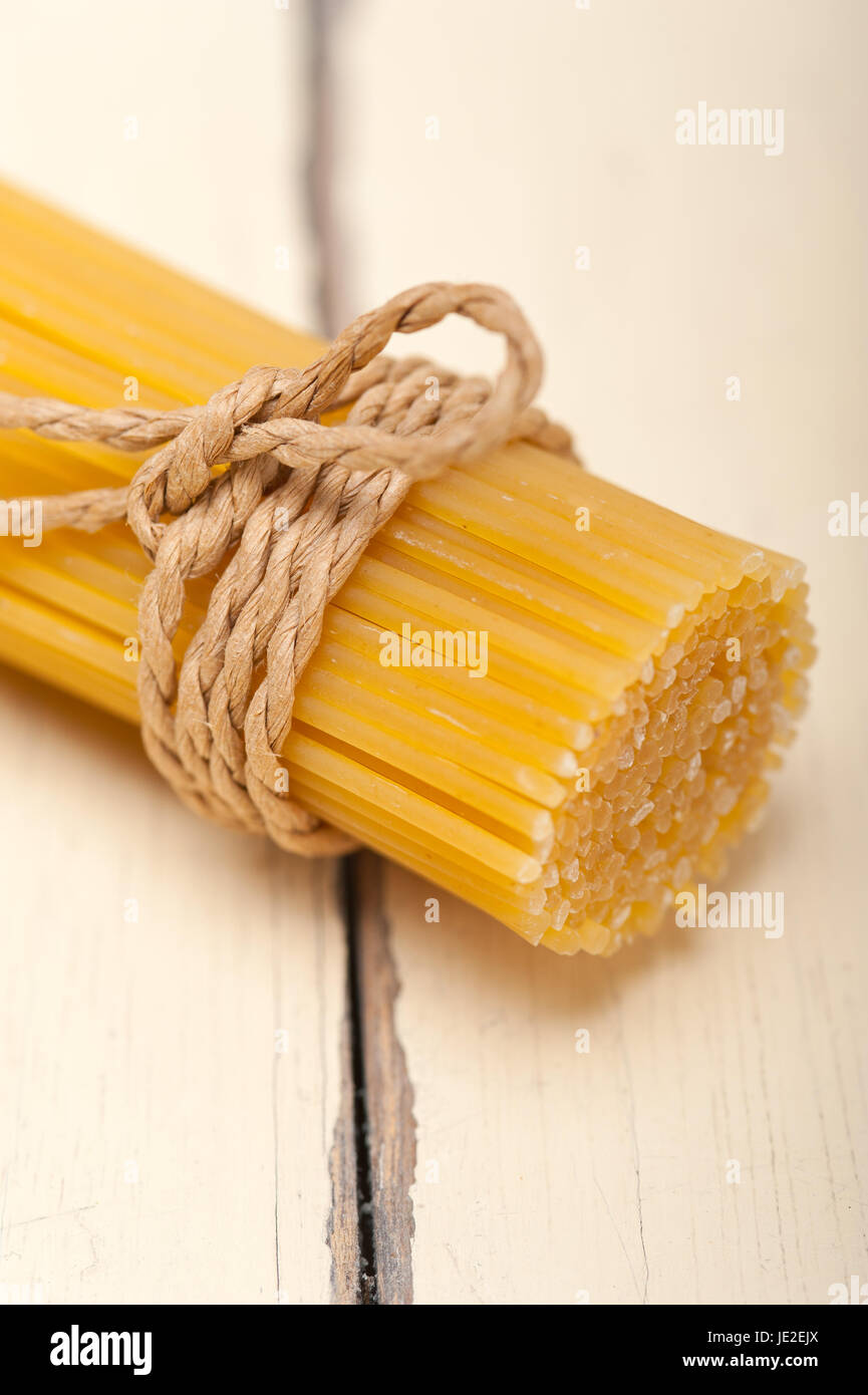 Italian pasta spaghetti tied with a rope on a rustic table Stock Photo ...