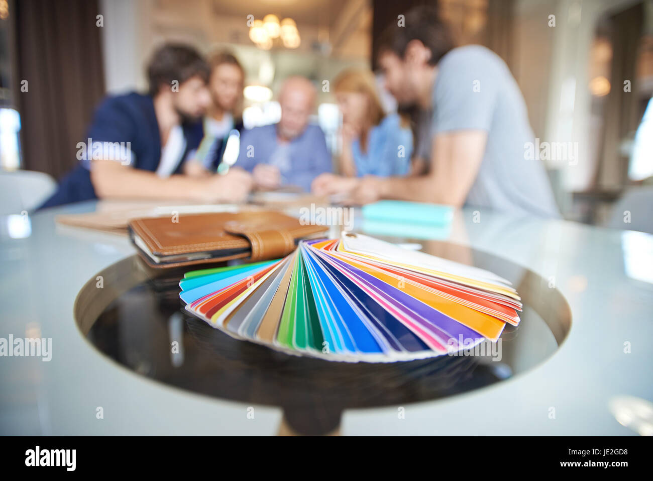 Color palette on workplace with group of business people on background ...