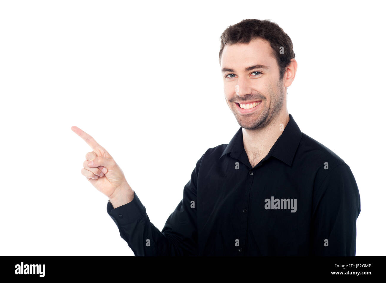 Handsome man pointing towards copy space area Stock Photo - Alamy