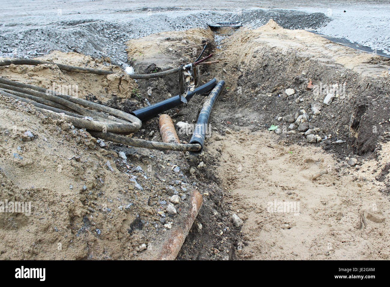 Protective PVC corrugated pipe with electrical cables inside, laid in ...